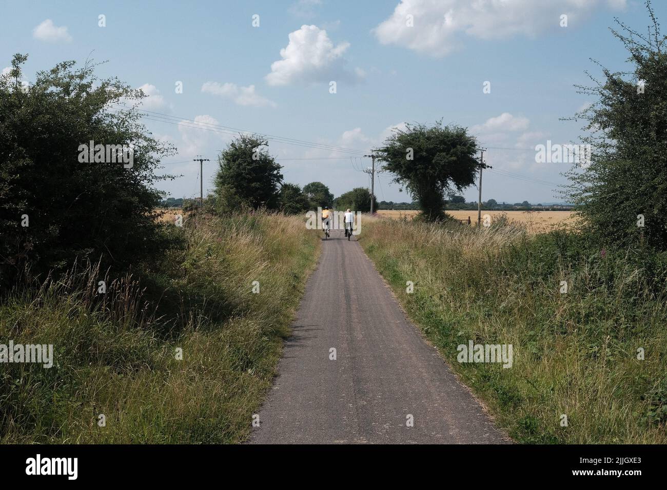 Two cyclists ride into the distance along the Trans Pennine Trail cycle ...