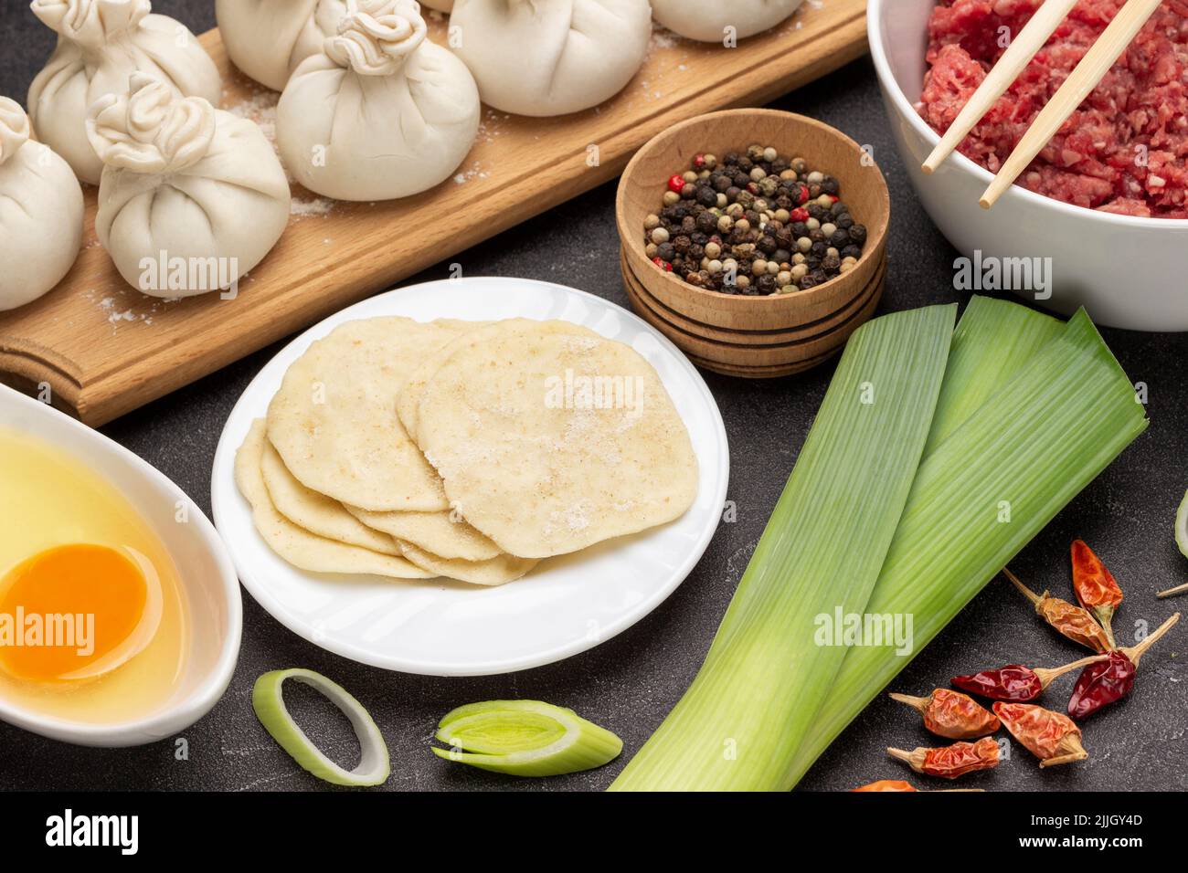 Ingredients for making dumplings. Meat filling, spices, leek and dough ...