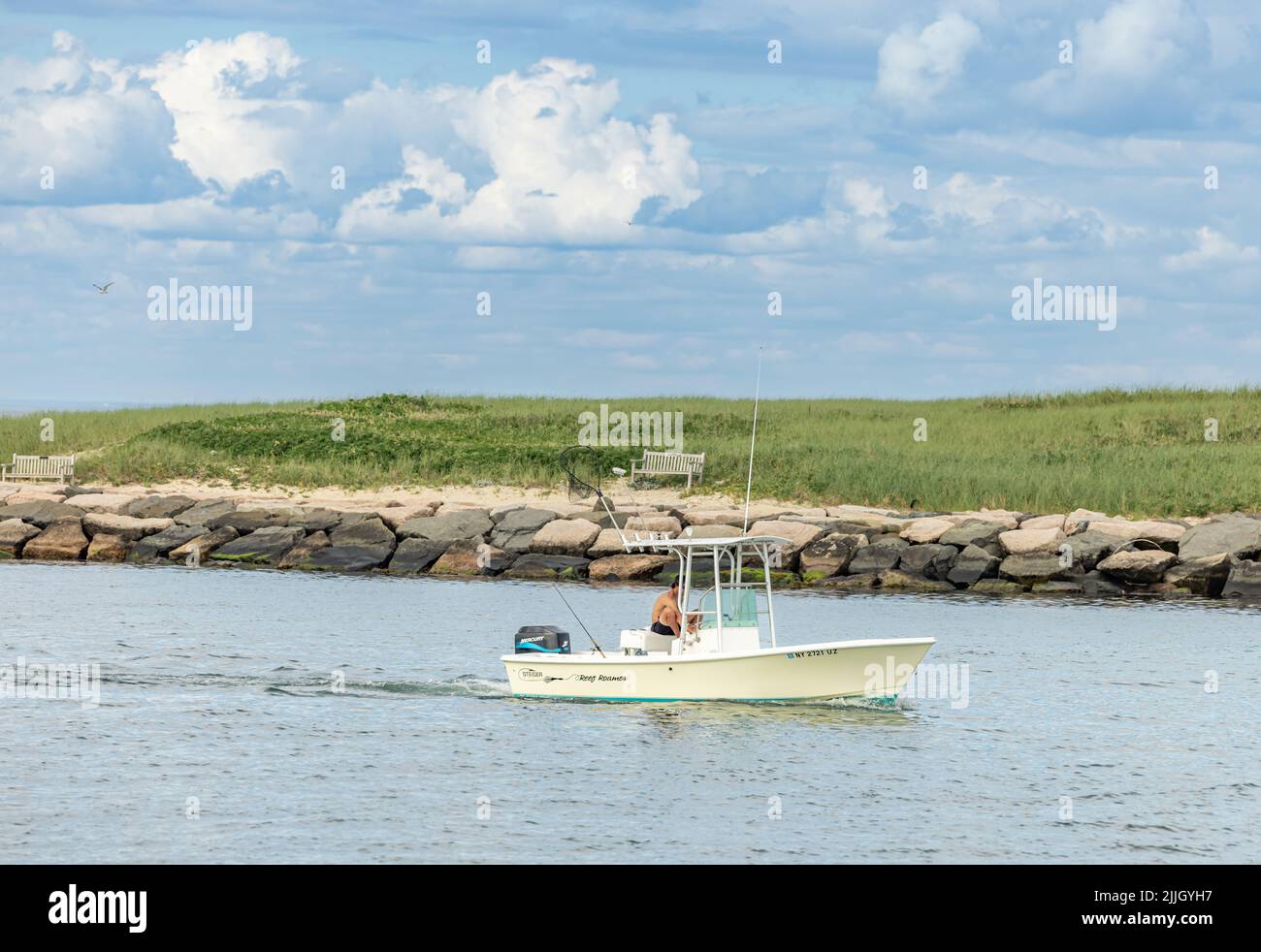 small boating coming into Montauk Harbor Stock Photo - Alamy