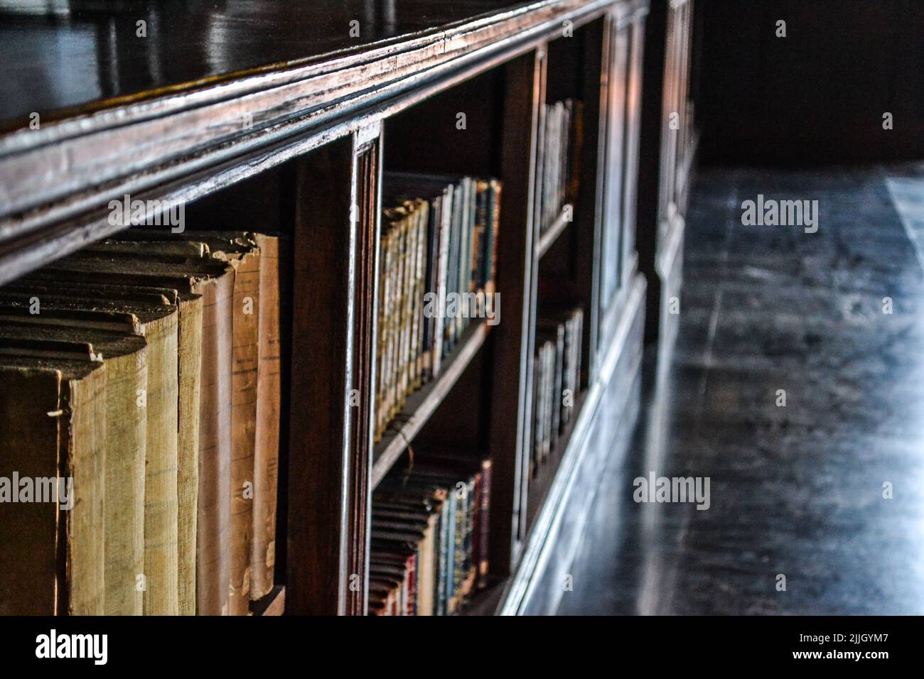 Old vintage books in a library Stock Photo - Alamy