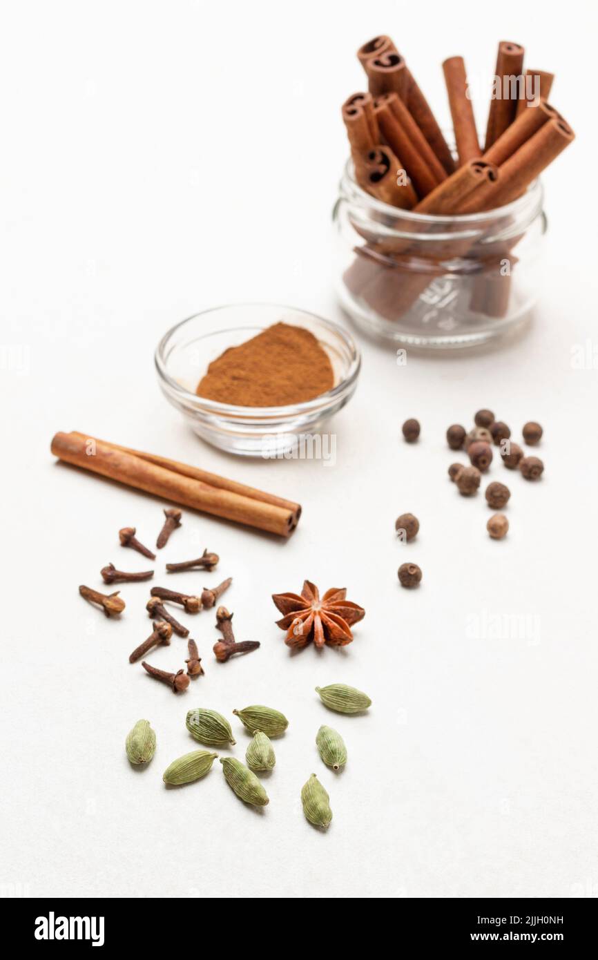 Cardamom, cloves and star anise on the table. Cinnamon sticks in a ...
