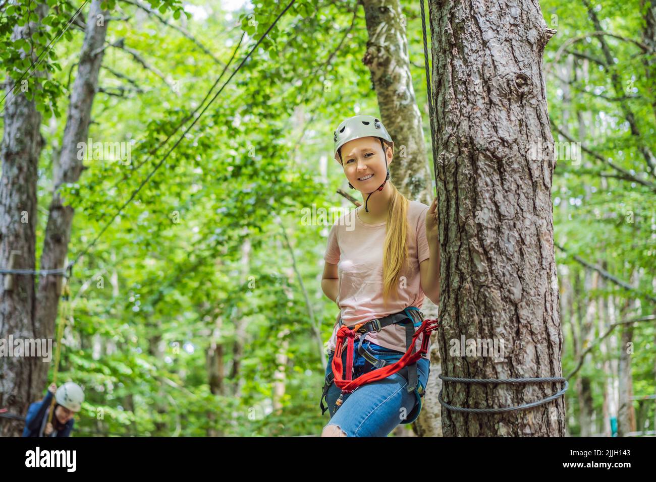 Happy women girl female gliding climbing in extreme road trolley ...