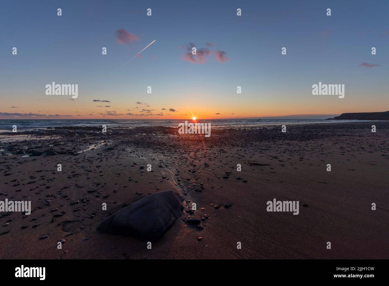 Widemouth Bay near Bude in Cornwall. Sunset, the tides out leaving a ...