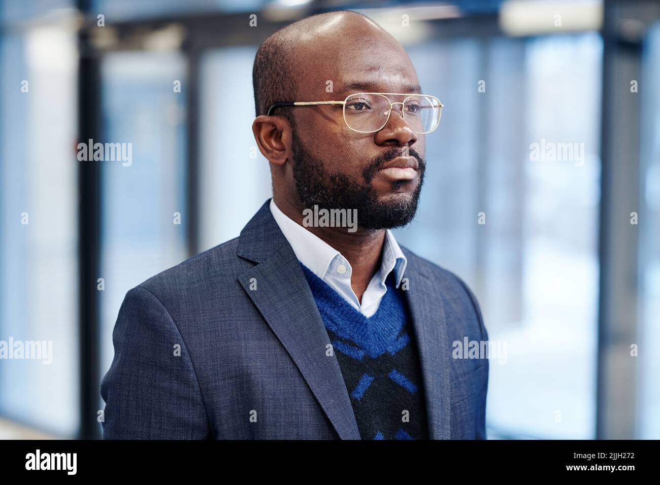 Close-up of African confident businessman in eyeglasses and formal wear ...