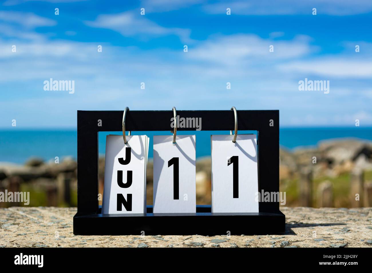 Jun 11 calendar date text on wooden frame with blurred background of ...