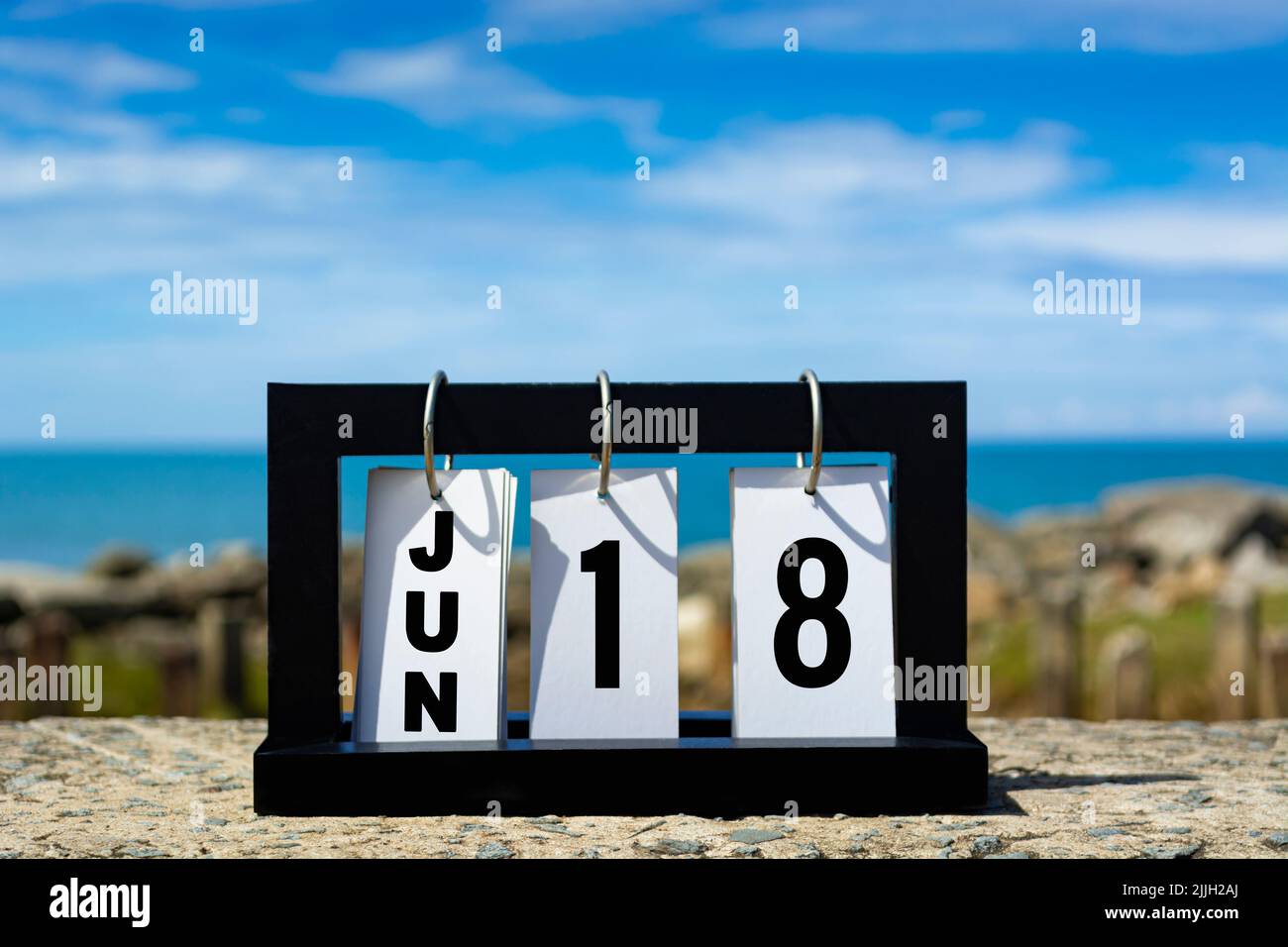 Jun 18 calendar date text on wooden frame with blurred background of ...