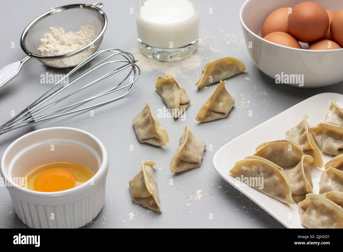 The process of making gyoza dumplings. Gyoza on table and on plate ...