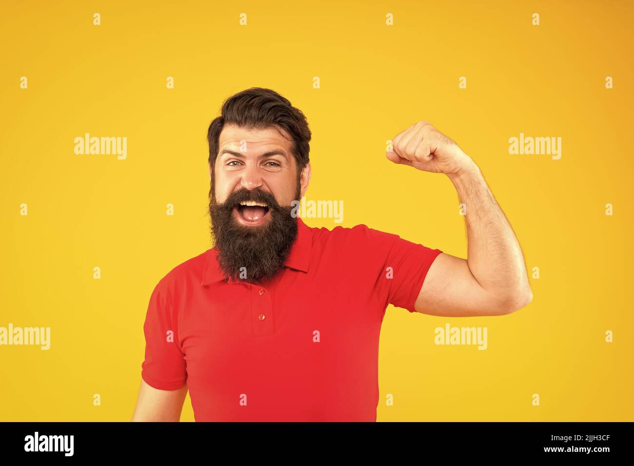 happy strong guy with beard and hairstyle on yellow background ...