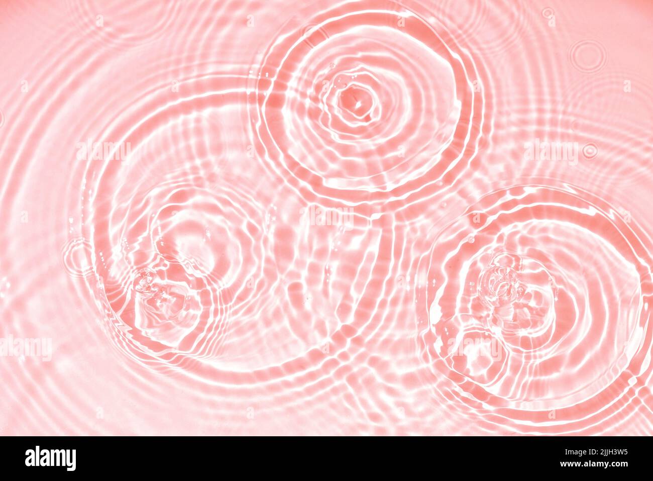 Pink water texture, cosmetic background pink water surface with rings ...
