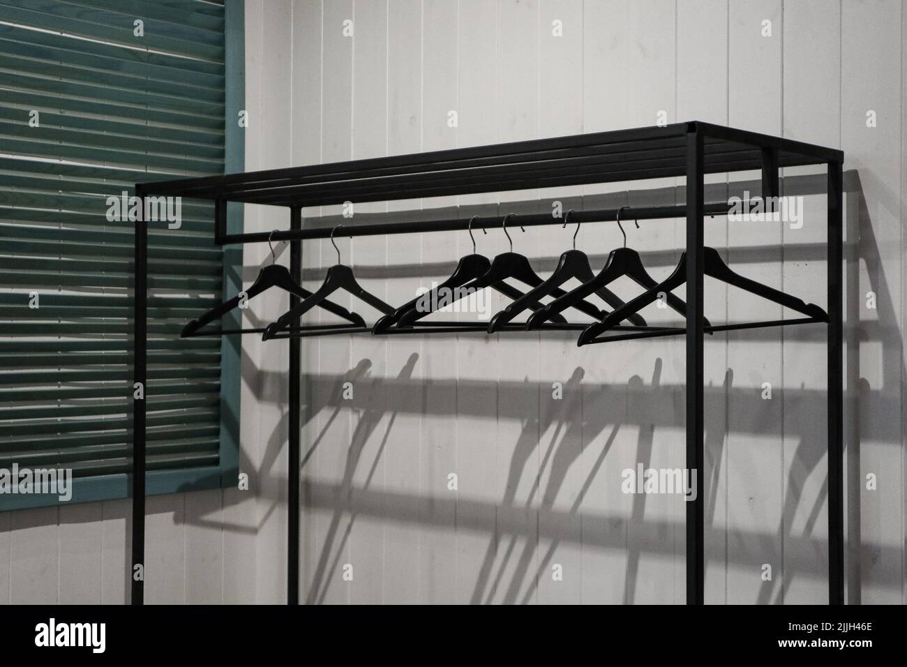 open metal hanger with hangers. open wardrobe Stock Photo - Alamy