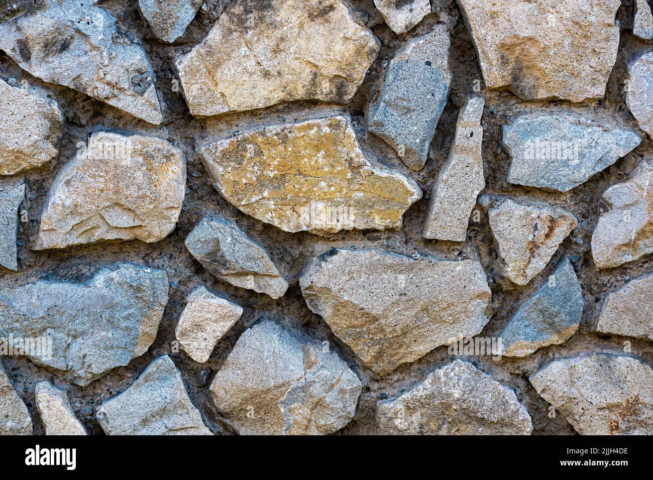 Texture, background for further work. A wall of coarse stone with a ...