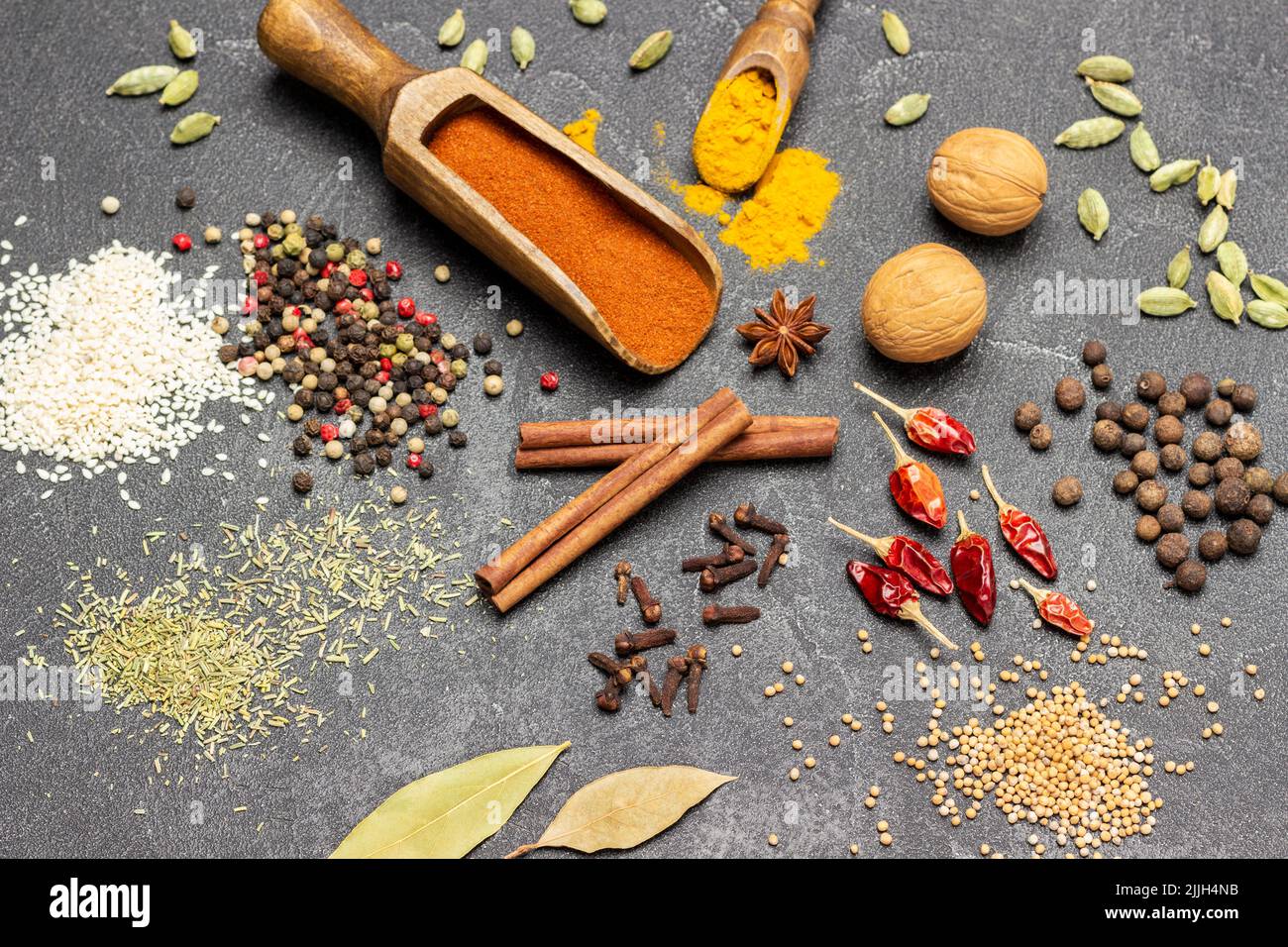 Set of dry spices on table. Ground paprika in wooden scoop. Top view ...