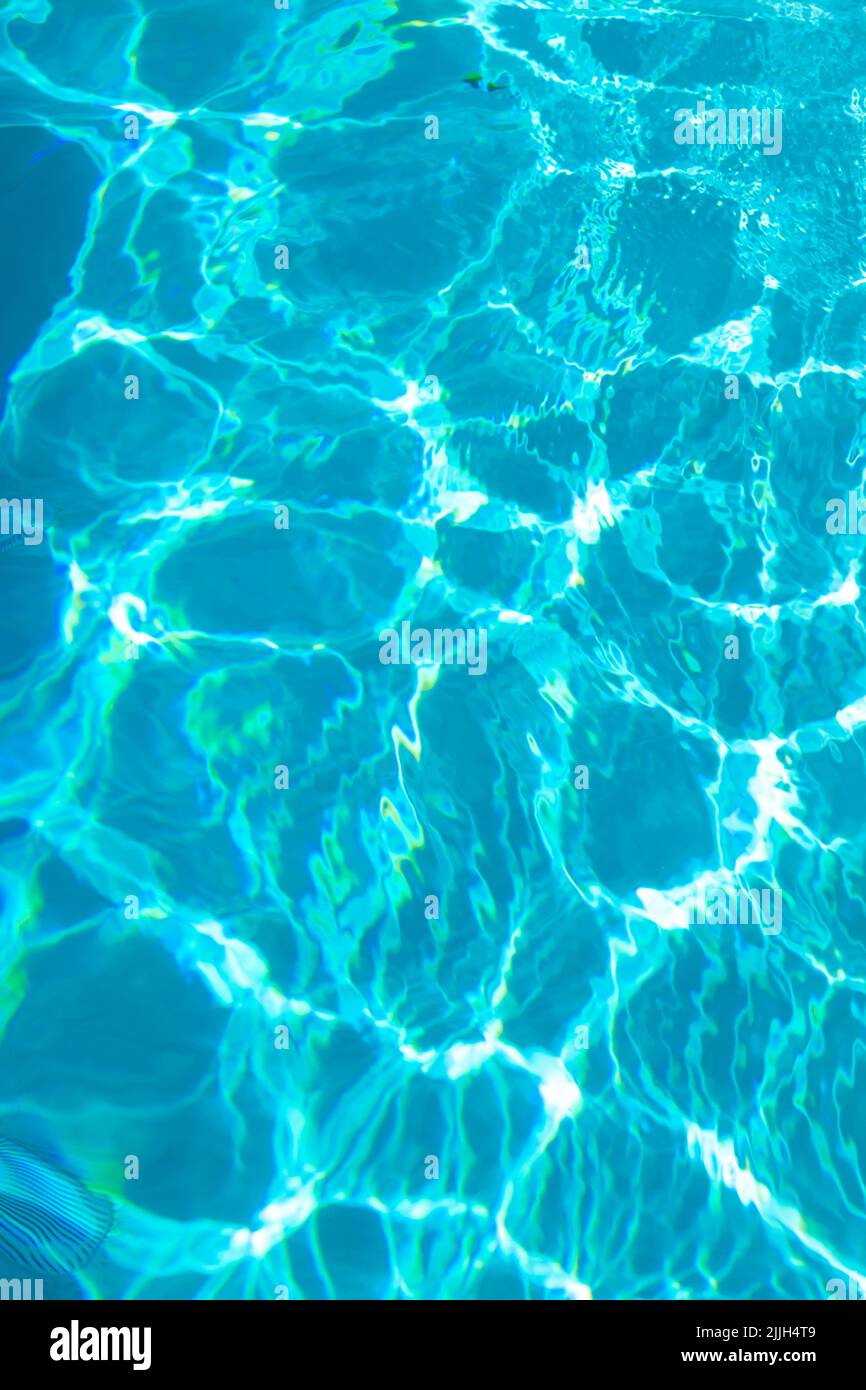 turquoise color background of swimming pool water with ripples in ...
