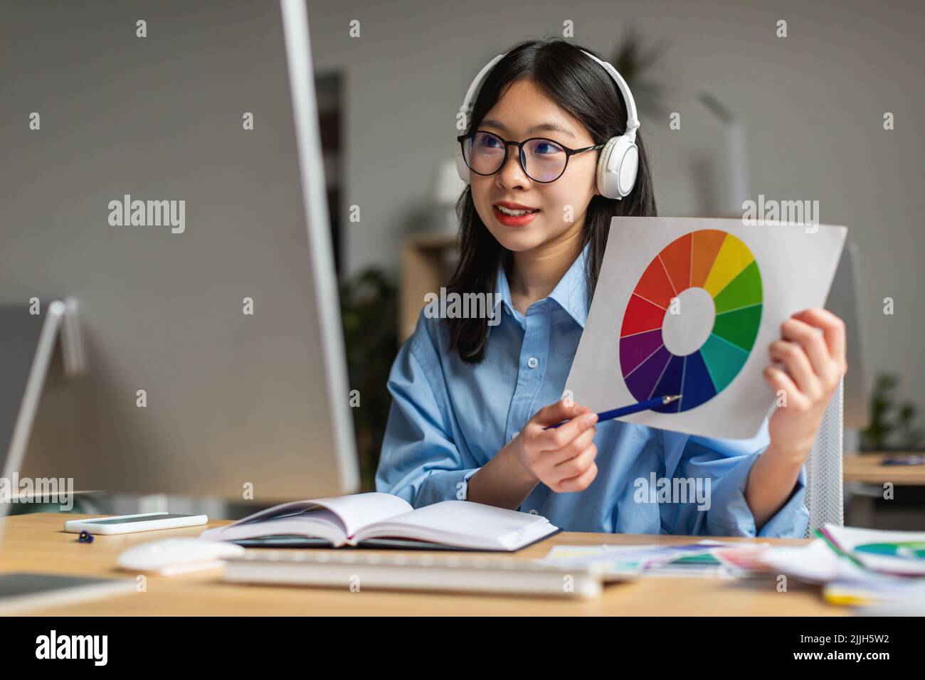 Korean Lady Video Calling Showing Color Palette To Computer Indoor ...