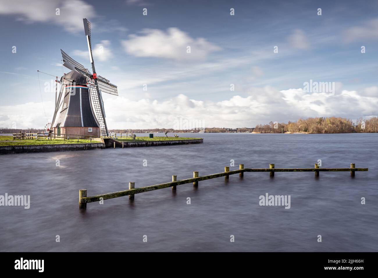 Waterways of Holland and view on traditional Dutch wind mill, Dutch ...