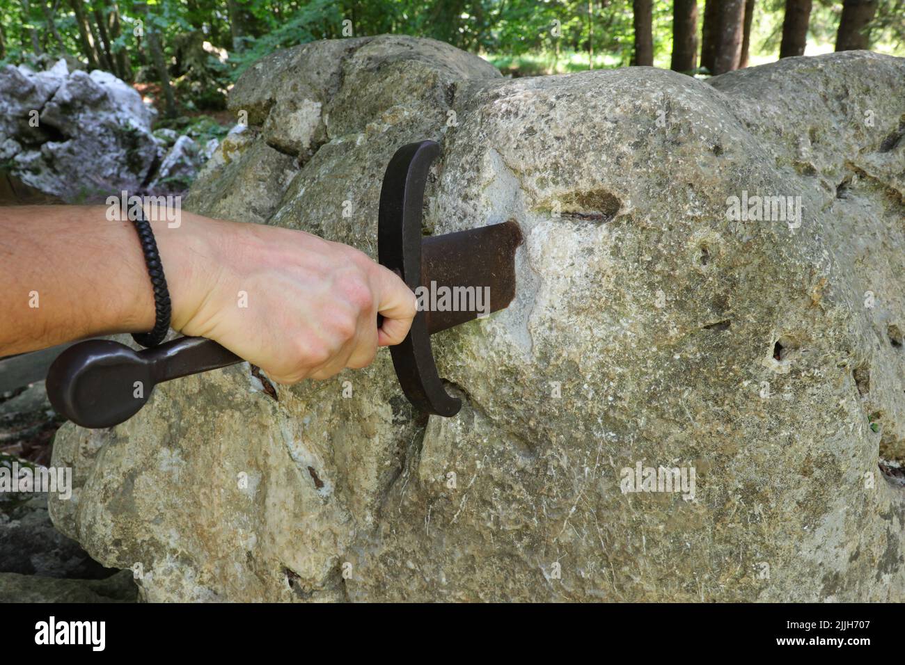 hand of knight and sword in the stone as in the legend of King Arthur ...