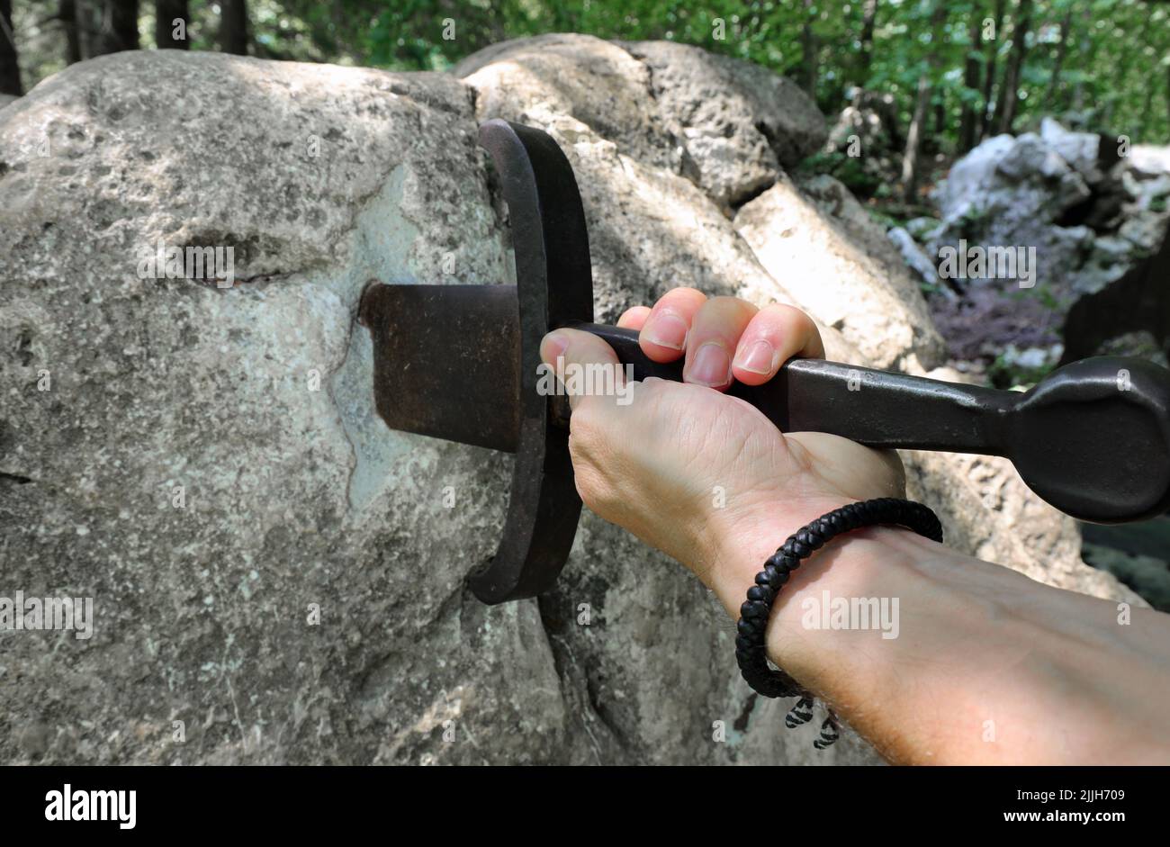 hand of knight and sword in the stone as in the legend of King Arthur ...