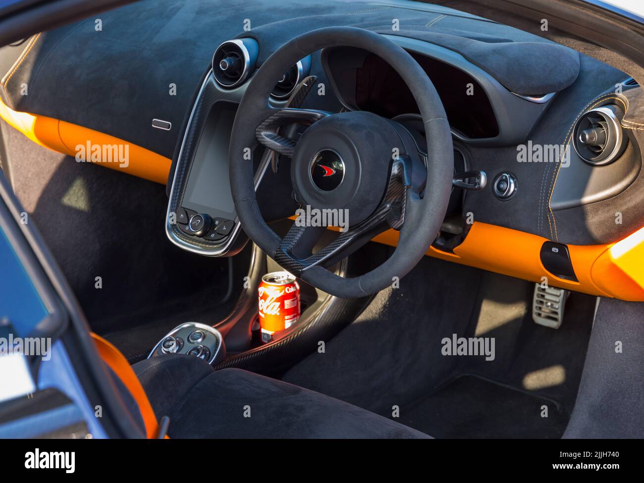 Looking inside McLaren supercar showing steering wheel and dashboard ...