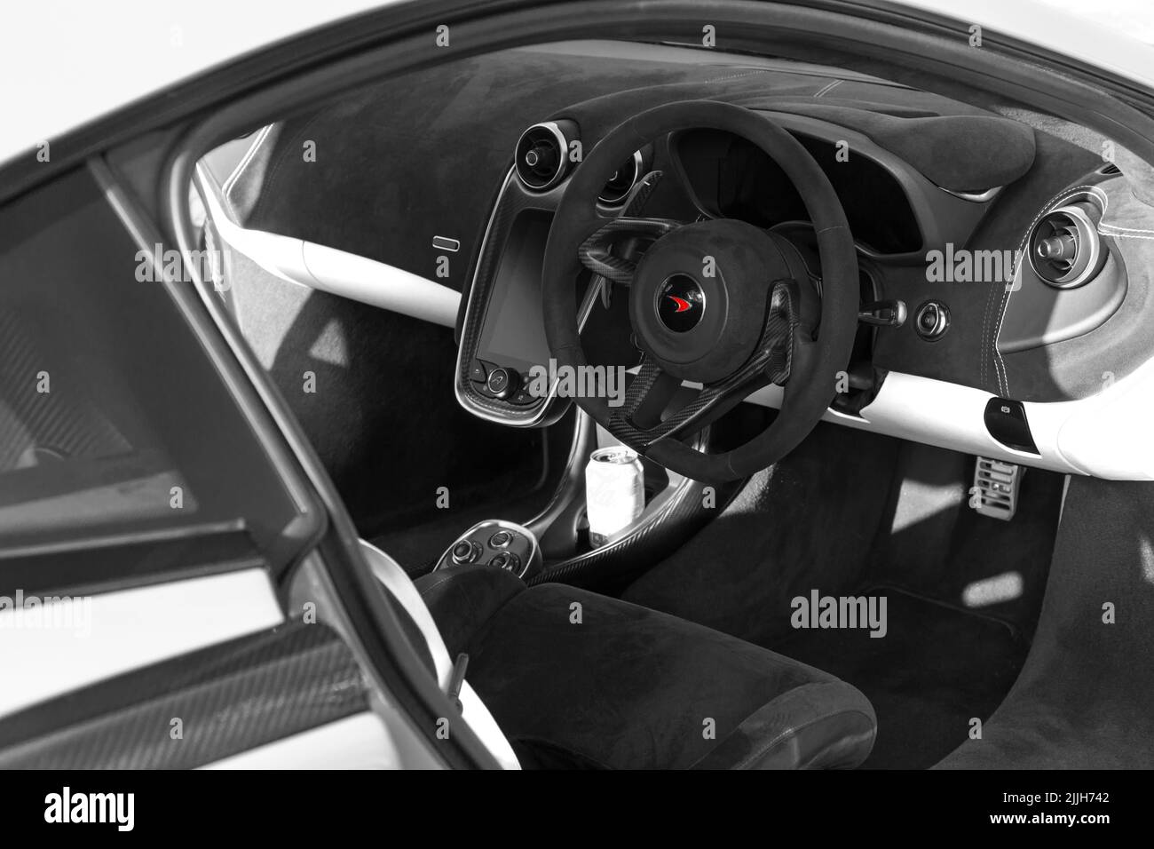 Looking inside McLaren supercar showing steering wheel and dashboard ...