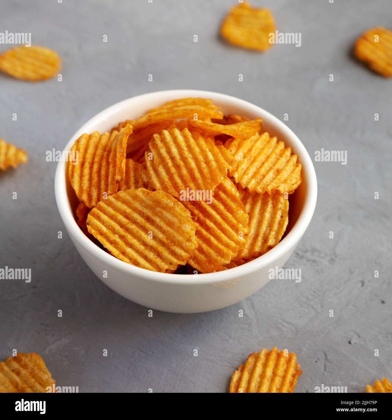 Crispy Barbeque Potato Chips in a Bowl on a gray background, side view ...