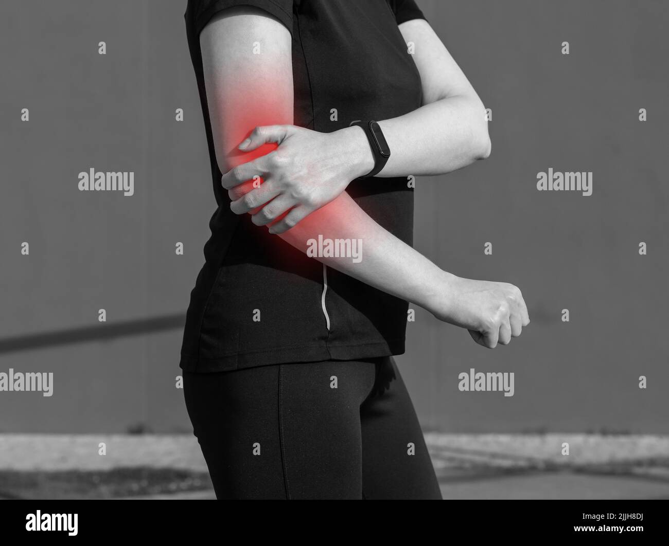 Sportswoman suffering from elbow pain with red point. Overuse ...