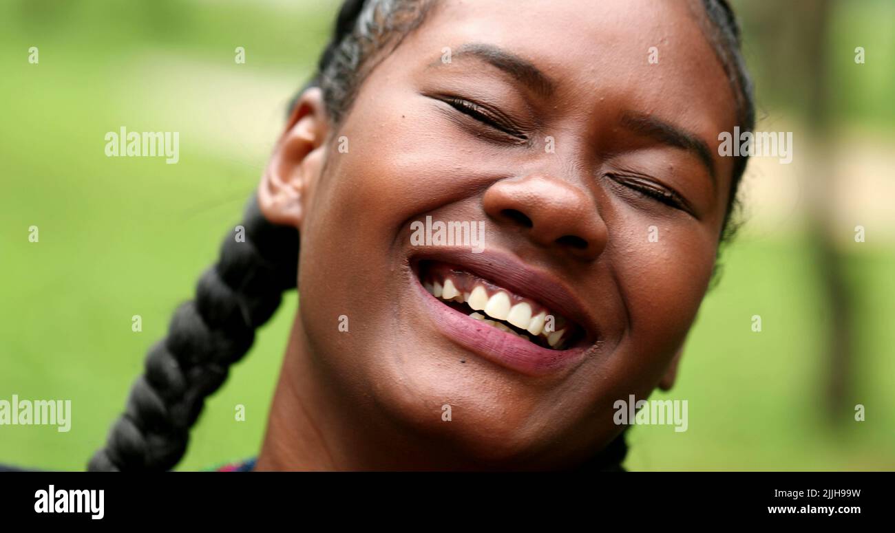 African girl laughing in park, close-up face authentic real life laugh ...