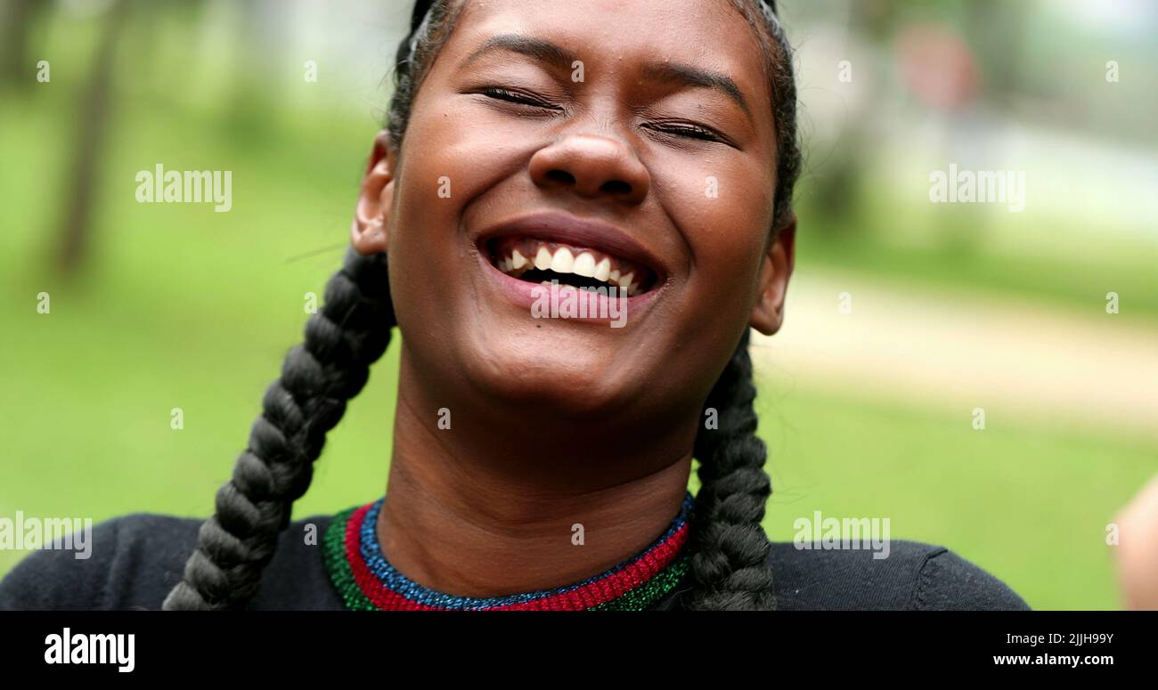 African girl laughing in park, close-up face authentic real life laugh ...