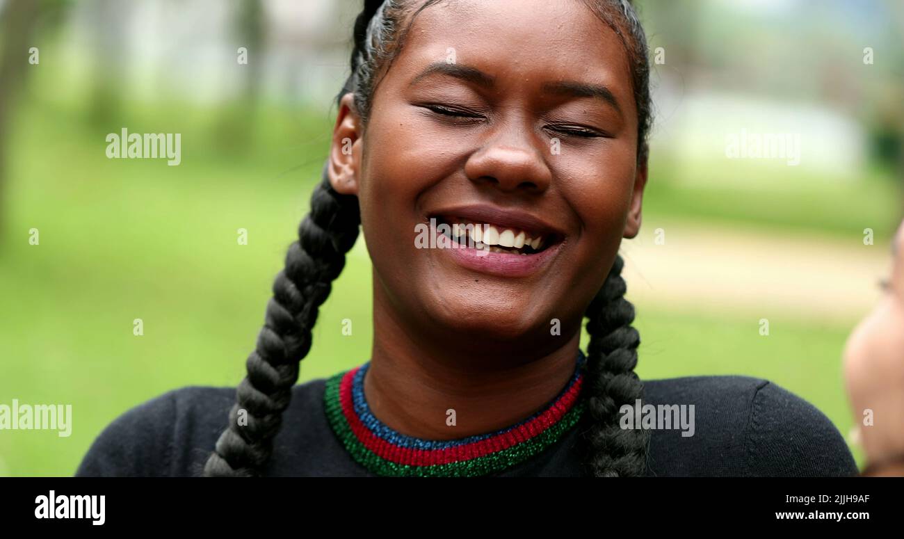 African girl laughing in park, close-up face authentic real life laugh ...