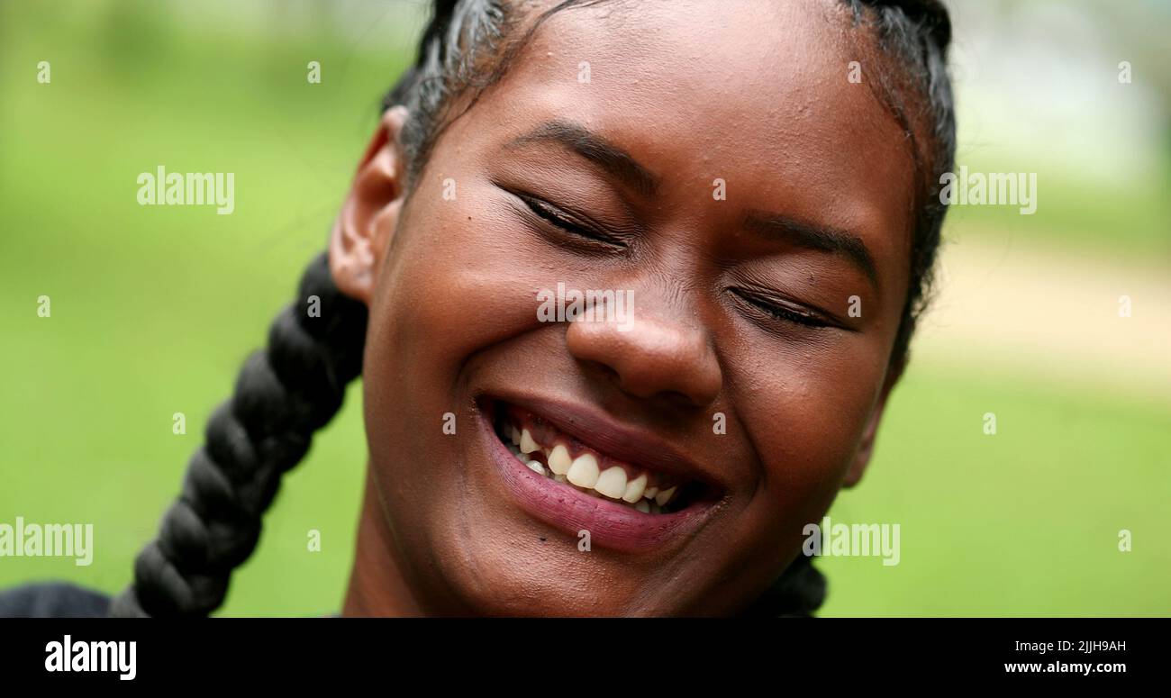 African girl laughing in park, close-up face authentic real life laugh ...
