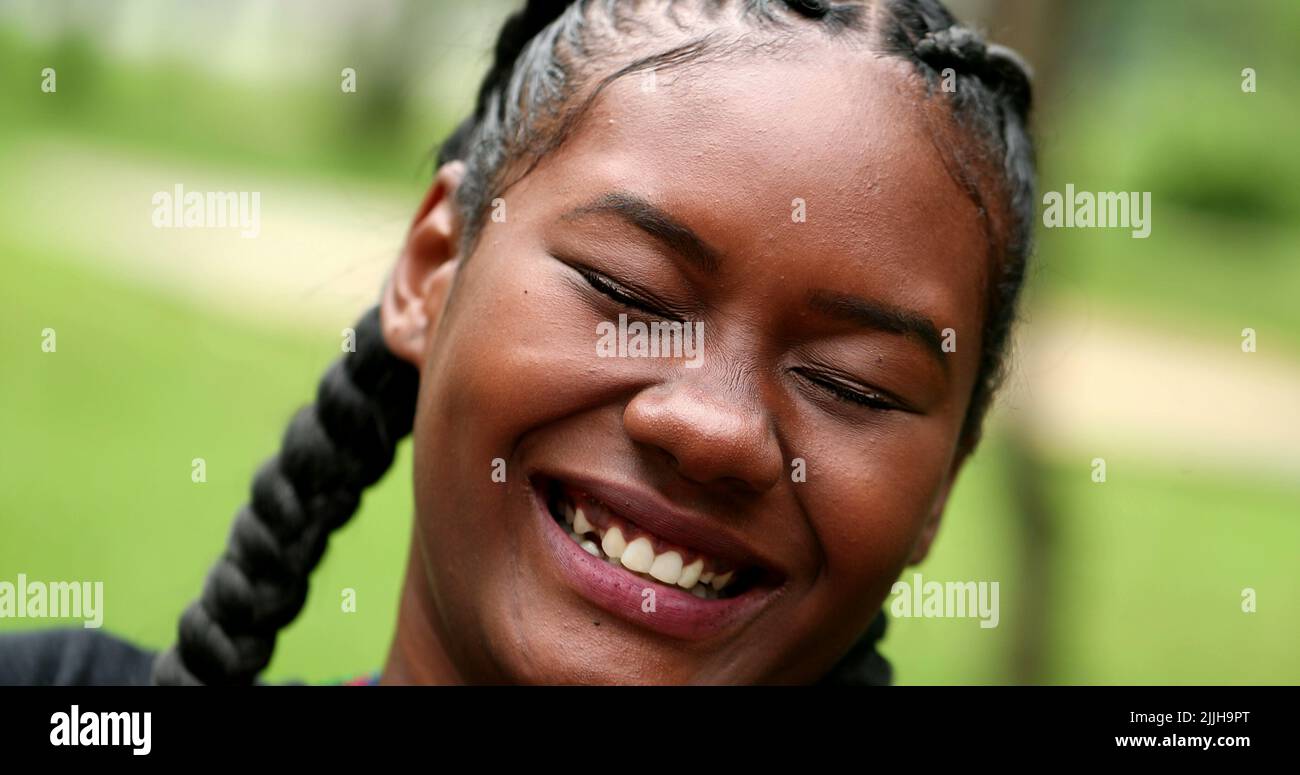 Black girl laughing covering face with hand. real life laugh Stock ...