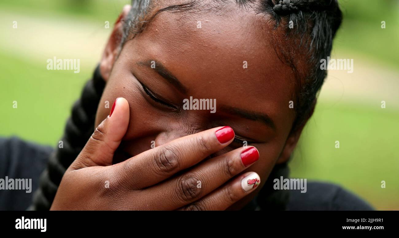 Black girl laughing covering face with hand. real life laugh Stock ...