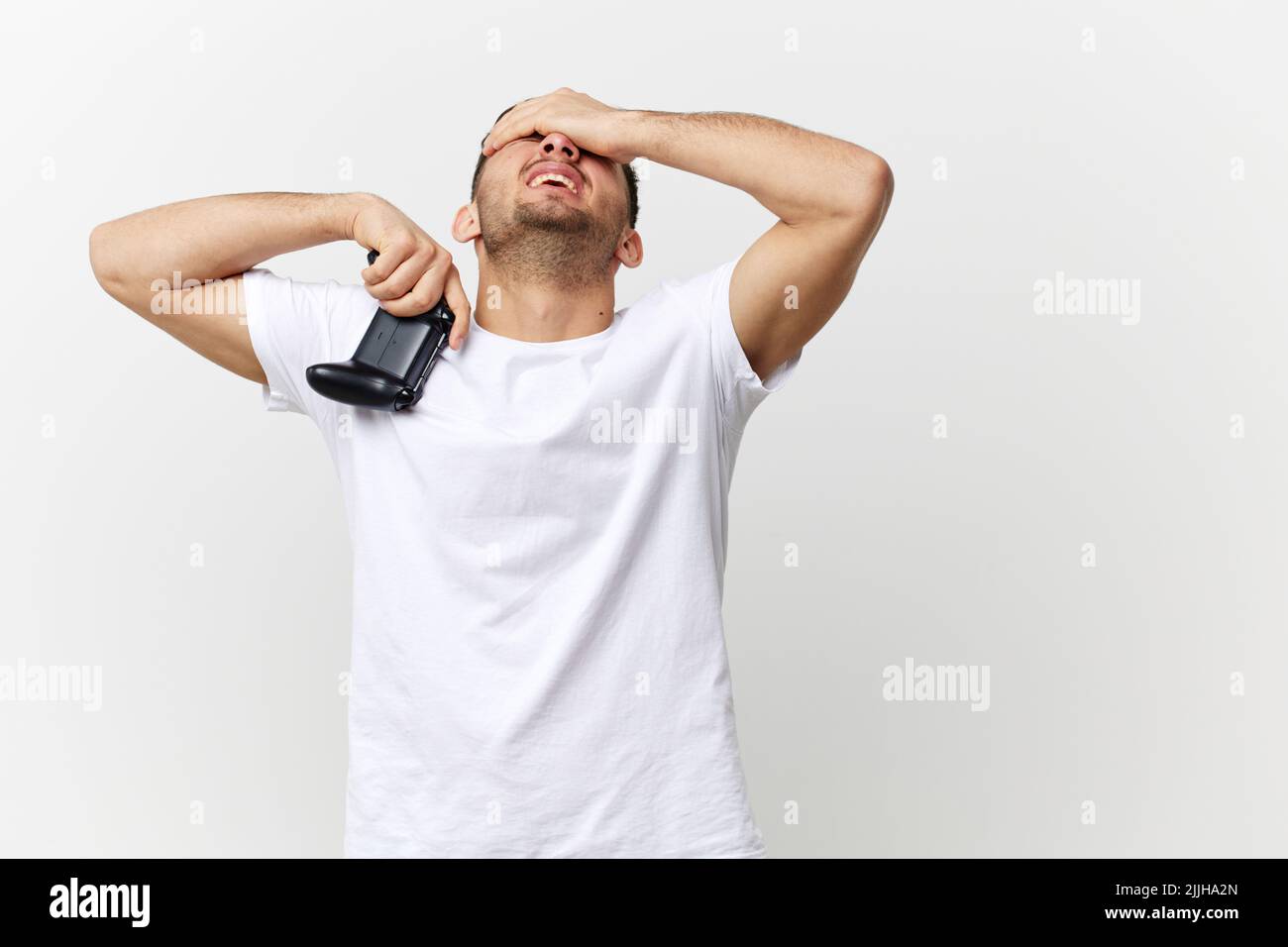 Tired frustrated sad tanned handsome man in basic t-shirt lose game ...