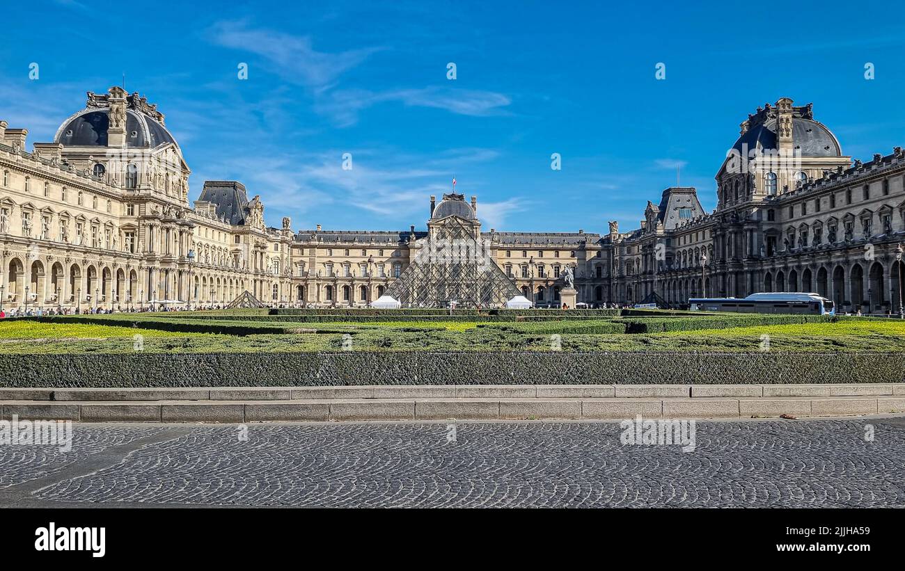 A beautiful view of the Louvre Museum in France under a blue sky Stock ...