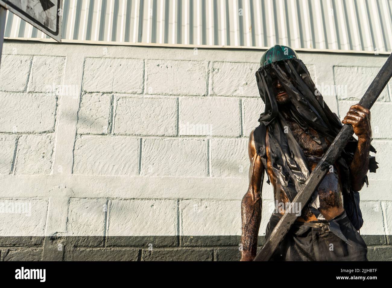 Chinegro de Santo Domingo bathed in burnt oil and carrying a stick ...