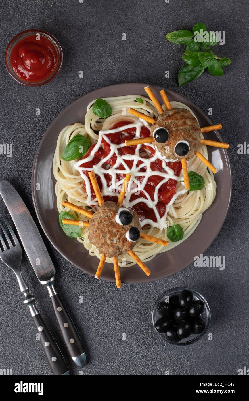 Cutlets look like spiders with olives and straws, served with spaghetti ...