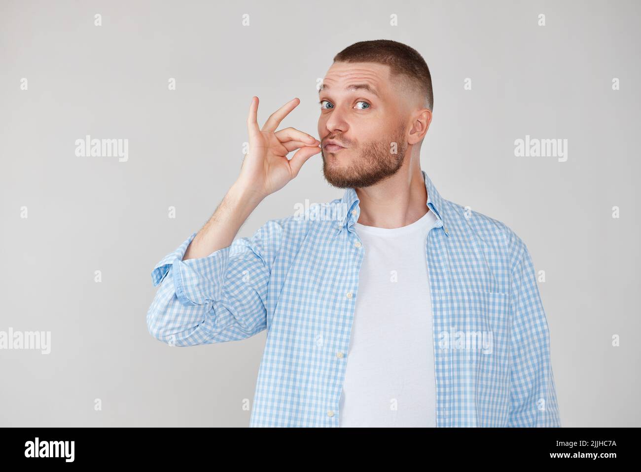 man with pouted lips showing gourmet sign with fingers tasty Stock ...