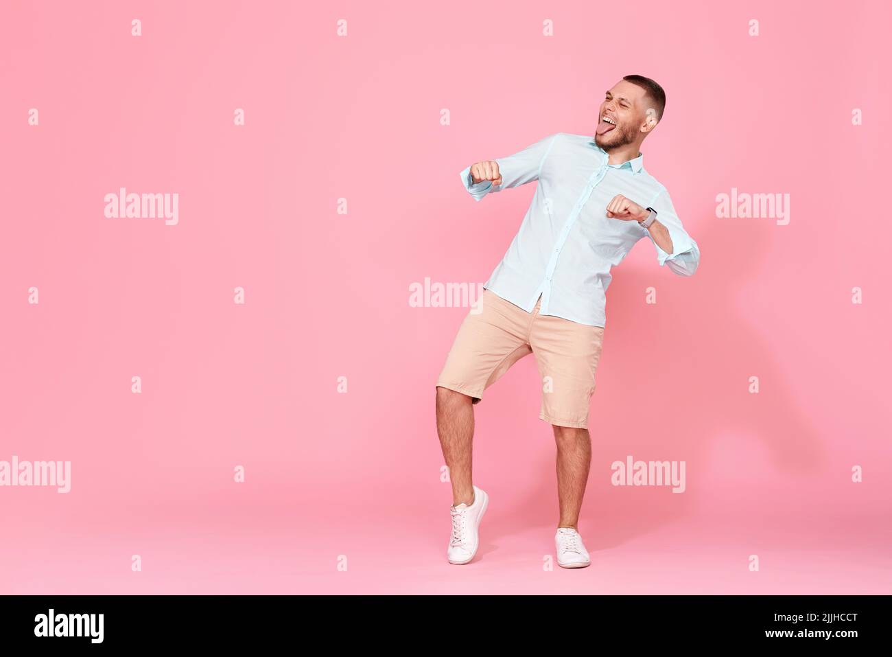 Man in blue shirt dancing hi-res stock photography and images - Alamy