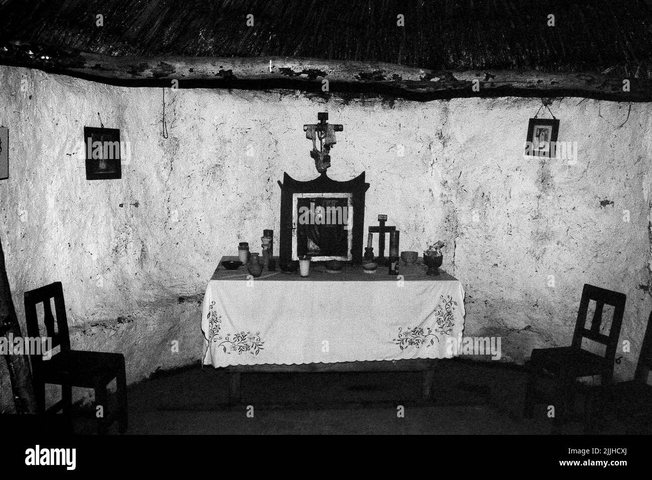 Interior of typical modern Mayan house, displaying catholic symbols ...