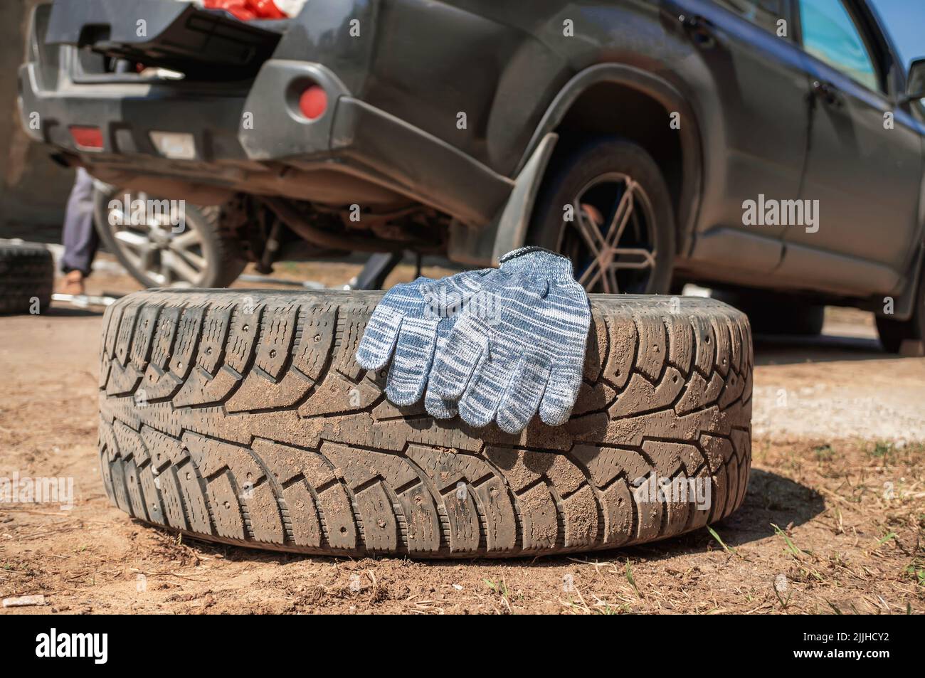 concept of replacing a spare wheel on the road with your own hands. The ...