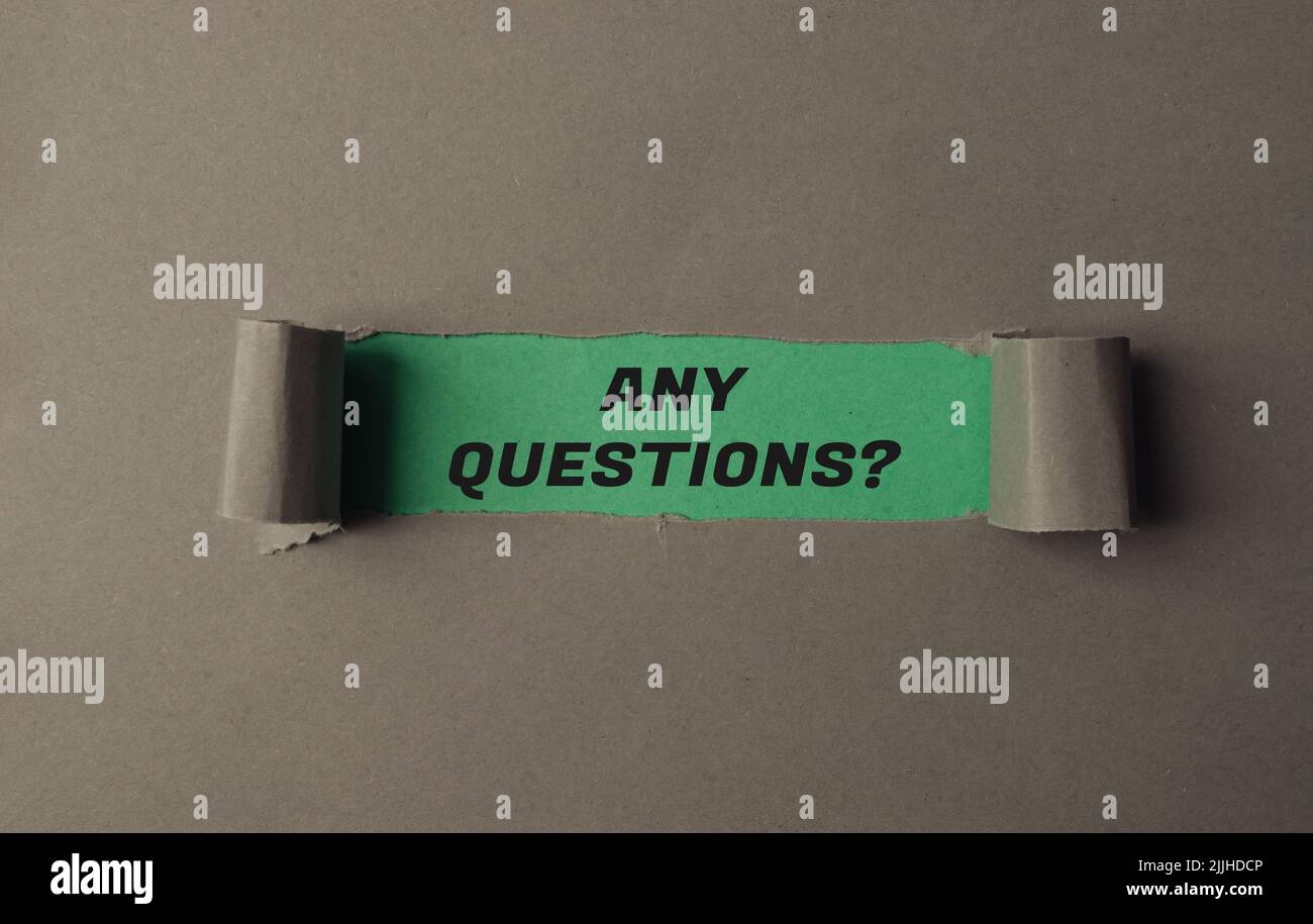 Text Any Questions on green view through torn paper Stock Photo - Alamy