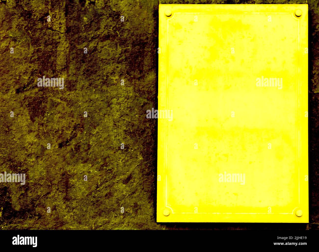 Yellow Plaque with place for text on brown granite wall Stock Photo - Alamy