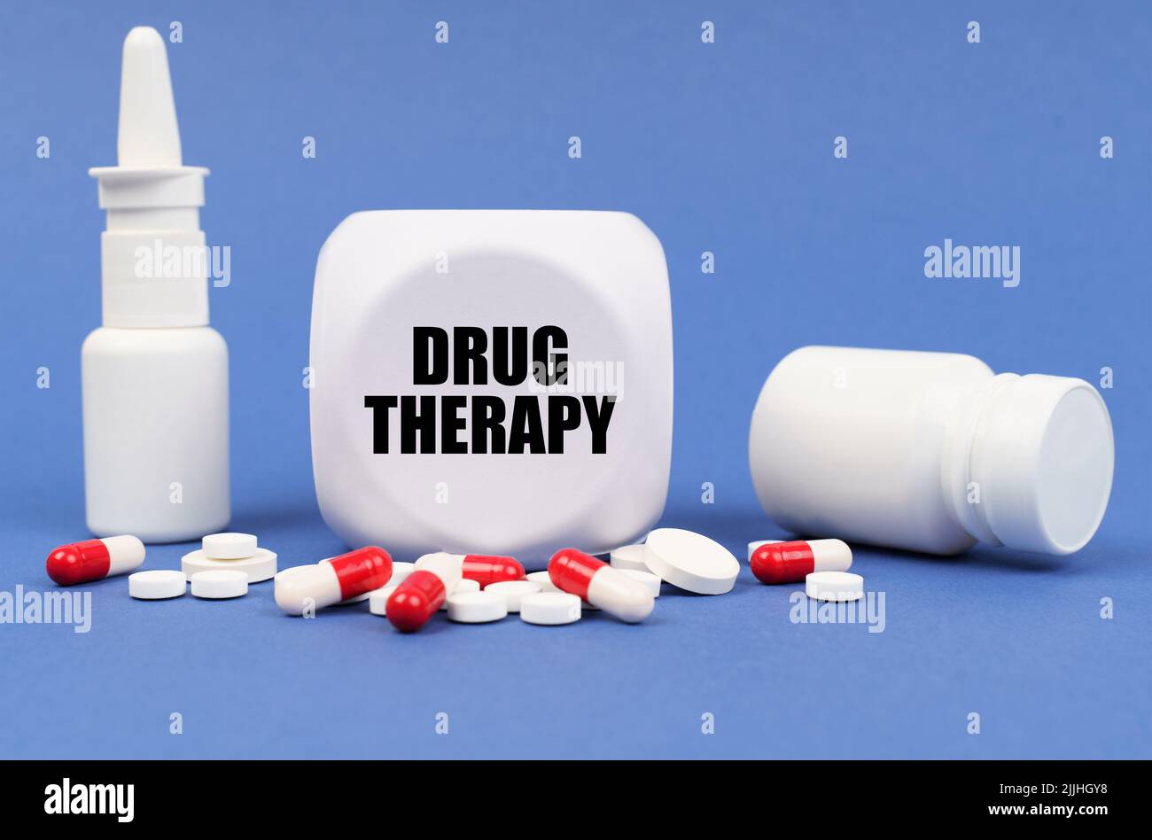 Medical concept. On the blue surface of the pill, capsule, spray, jar ...