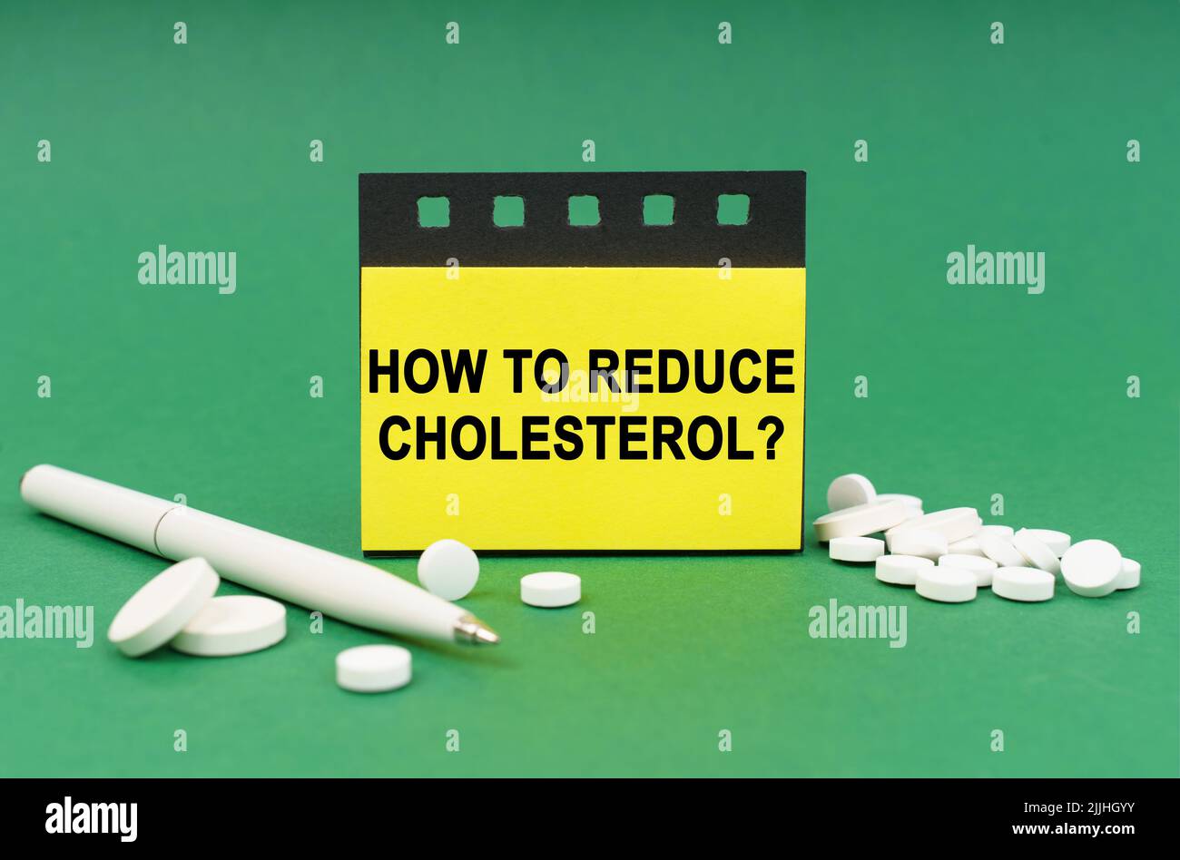 Medical concept. On the green surface are tablets, a pen and stickers ...