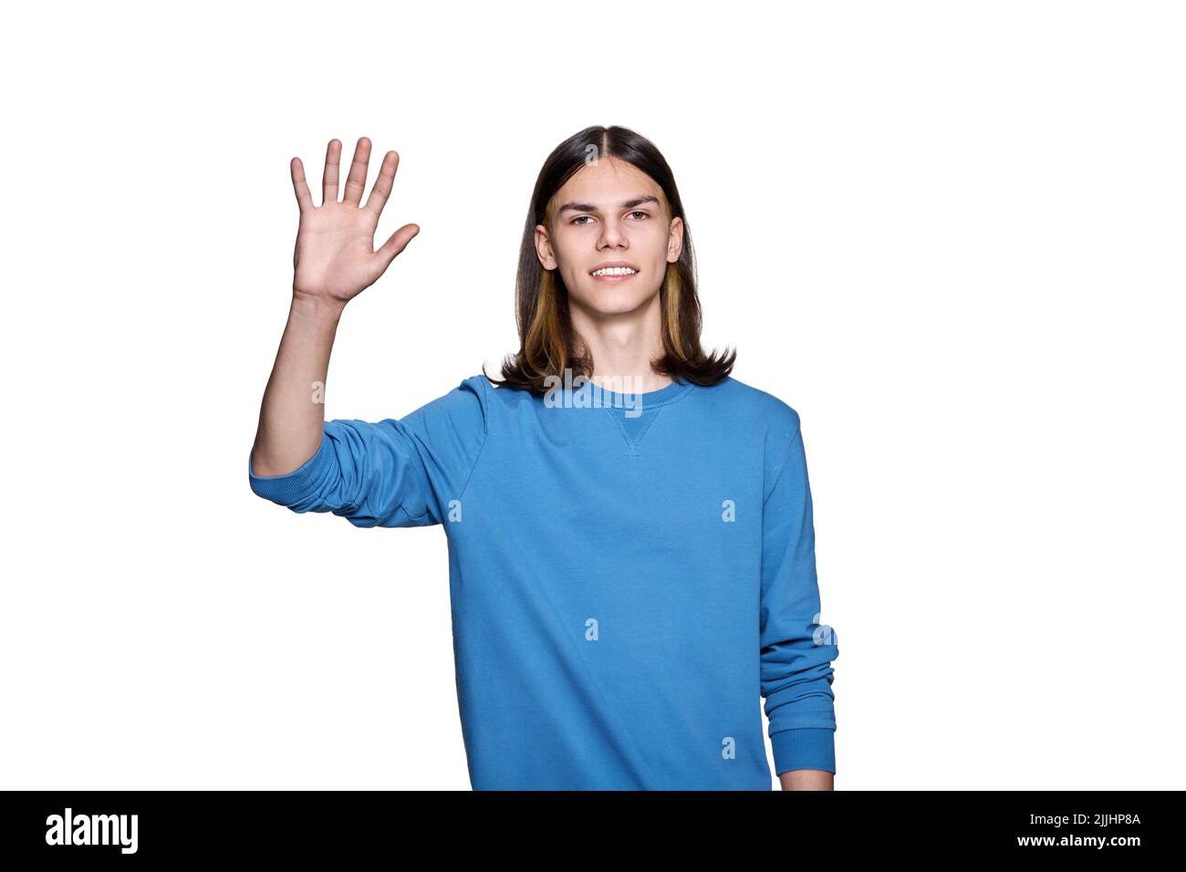 Young guy looking at camera waving his hand, on white isolated ...
