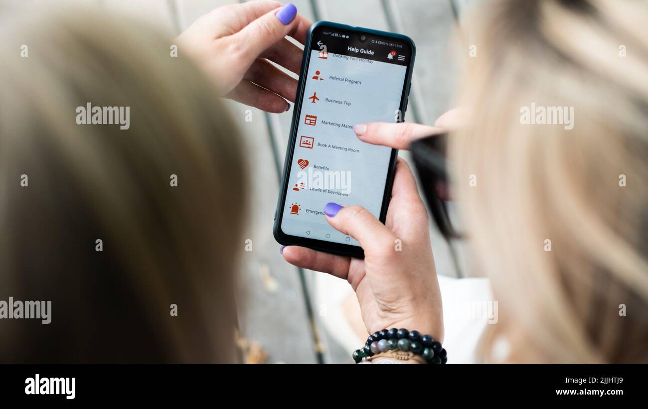 A view of the two girls using a mobile phone Stock Photo - Alamy