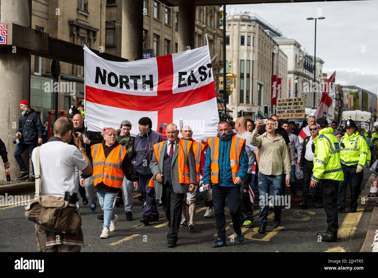 A group of people with flags participating in the EDL marches Stock ...