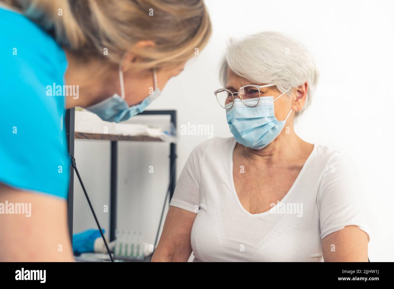 At the doctor's office - an old, retired lady smiling sincerely at her ...
