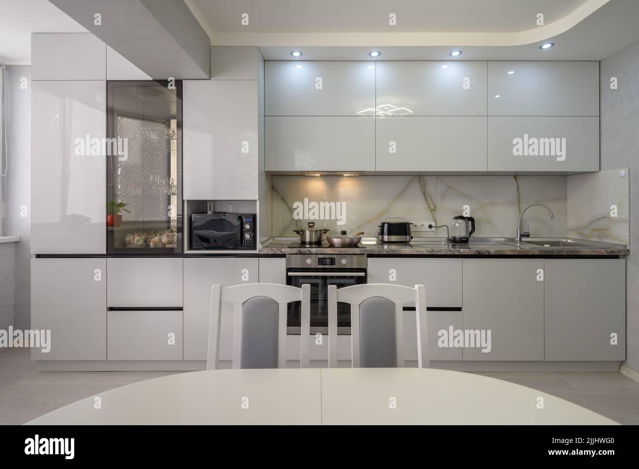 Interior of modern trendy white kitchen, front view Stock Photo - Alamy