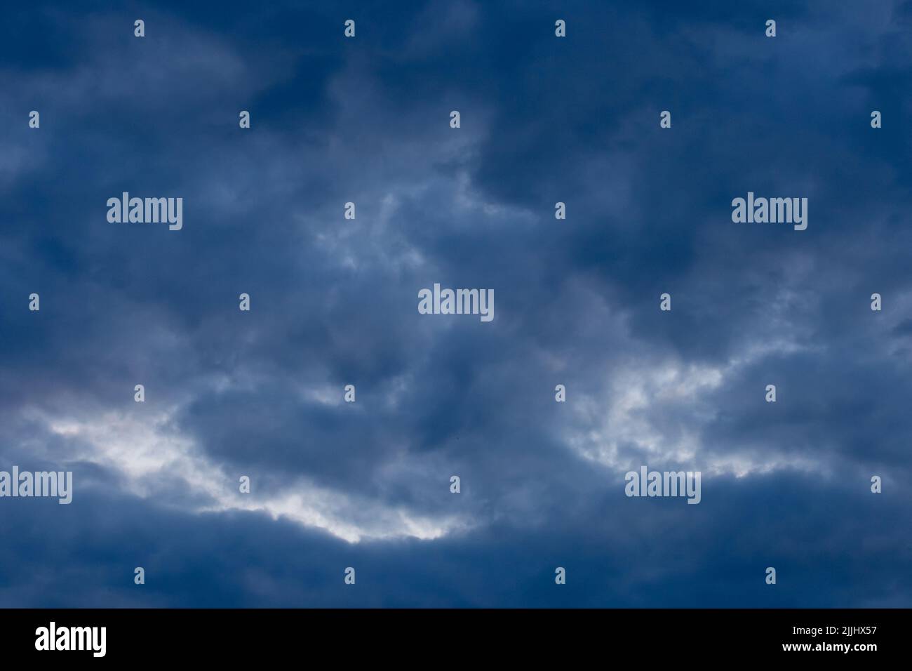 Light spot through dark rain clouds storm beam light sky weather ...