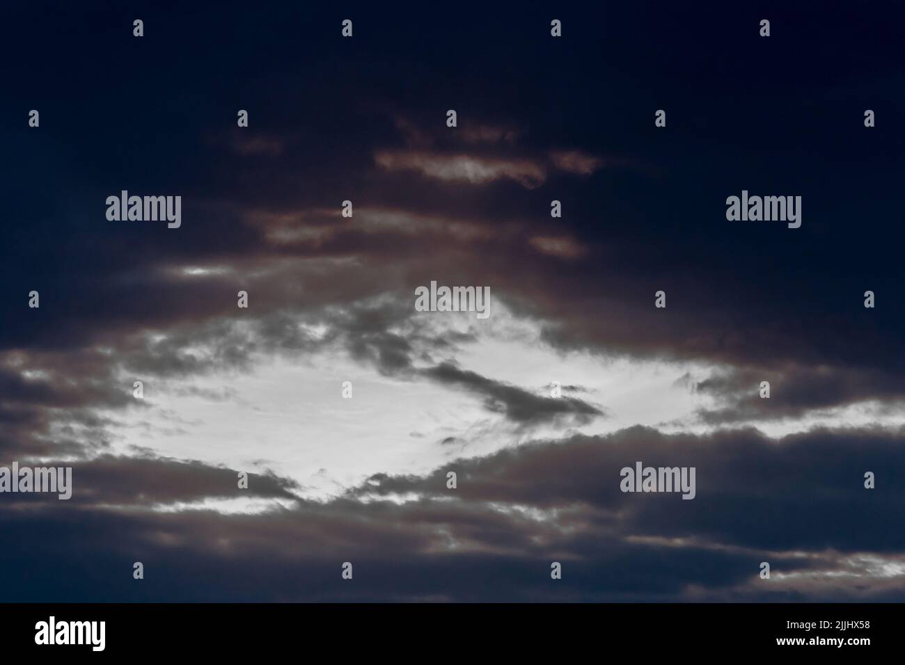 Light spot through dark rain clouds storm beam light sky weather ...